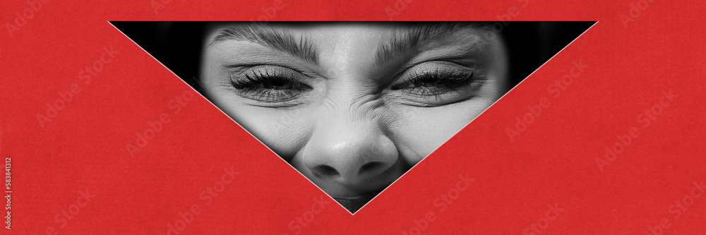 Grimacing face. Black and white part of female face in red background ...