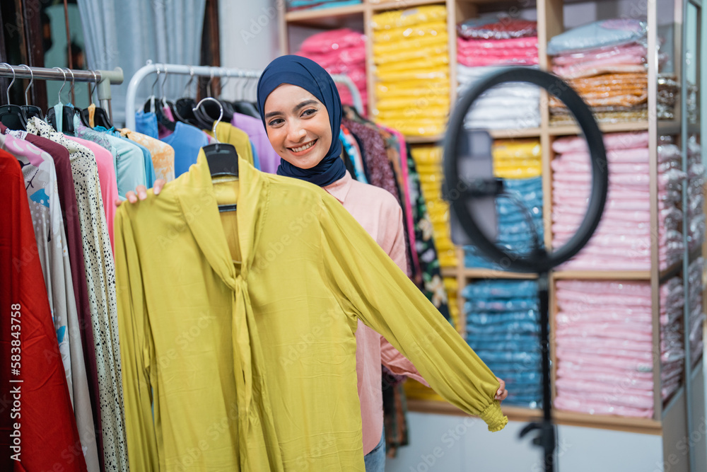 attractive muslim woman reviewing fashion product and doing live ...