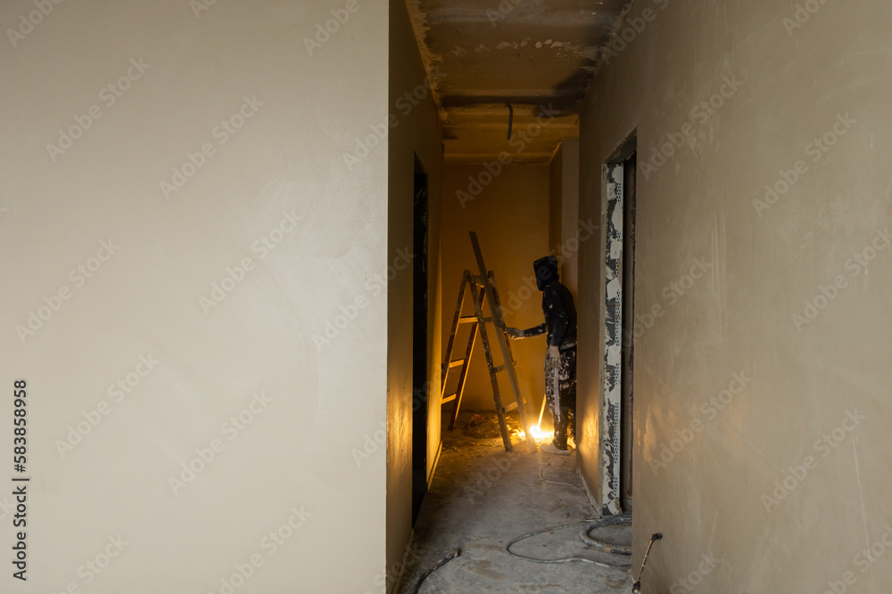 Construction worker wearing worker overall with wall plastering tools ...