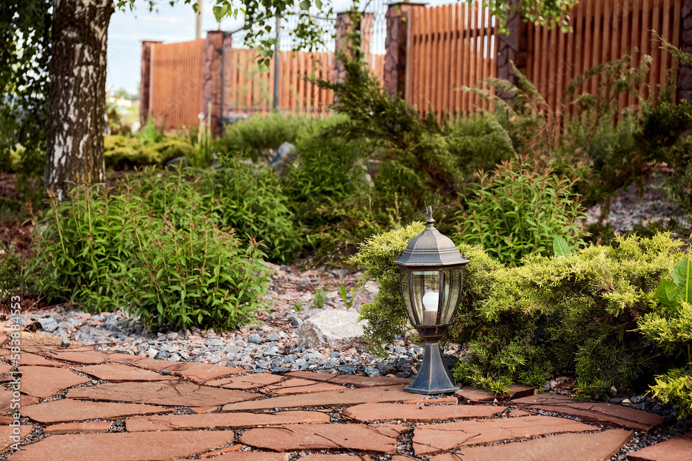 Entrance group of private house with wooden fence, stone pillars ...