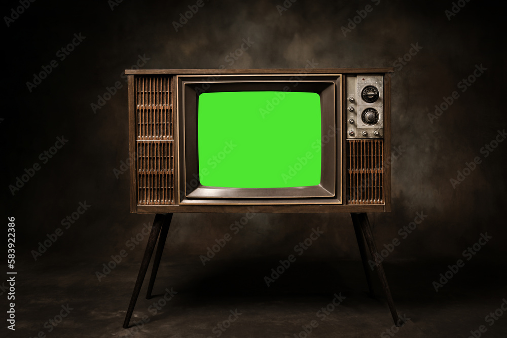 Retro old television with chroma key green screen standing in a dark ...