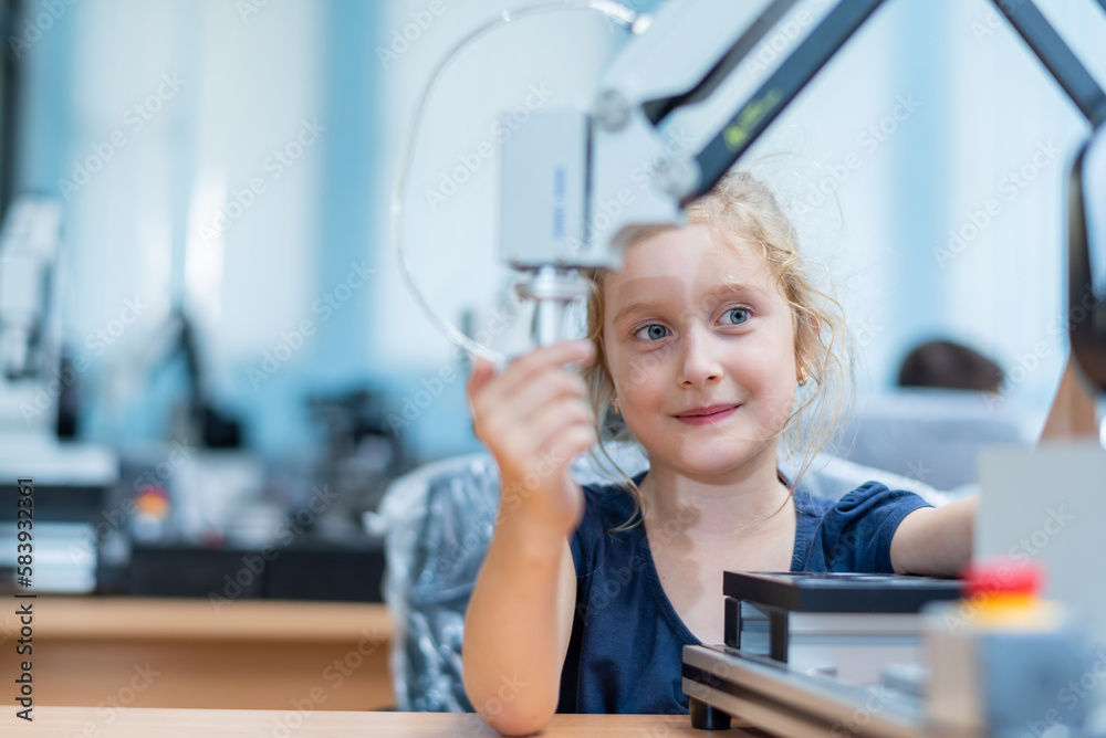 Kid female teen child enjoy Machine Learning Robot arm is Moving Under ...