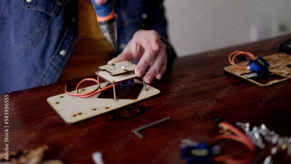 Robotic school project: Young student building robot vehicle at ...