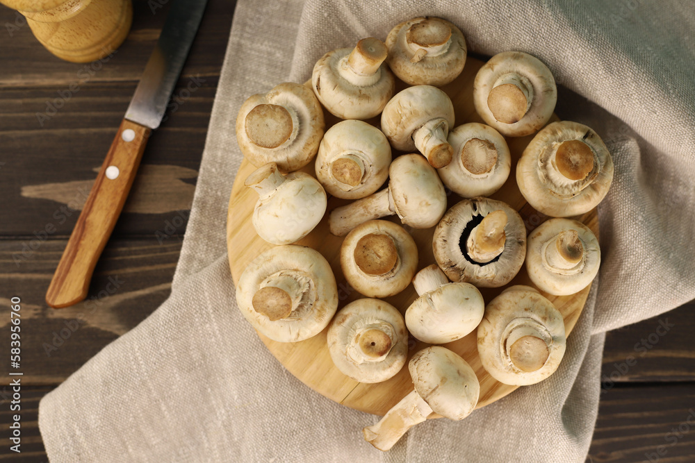 fresh large fragrant champignon mushrooms in a dark kitchen next to a ...