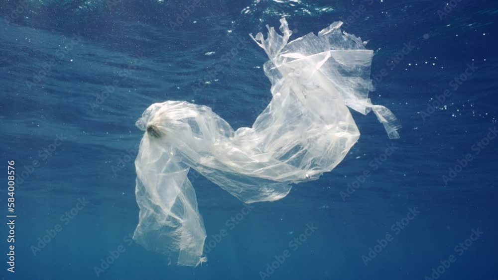 Plastic trash in water, bag floating underwater inside ocean. Slow ...
