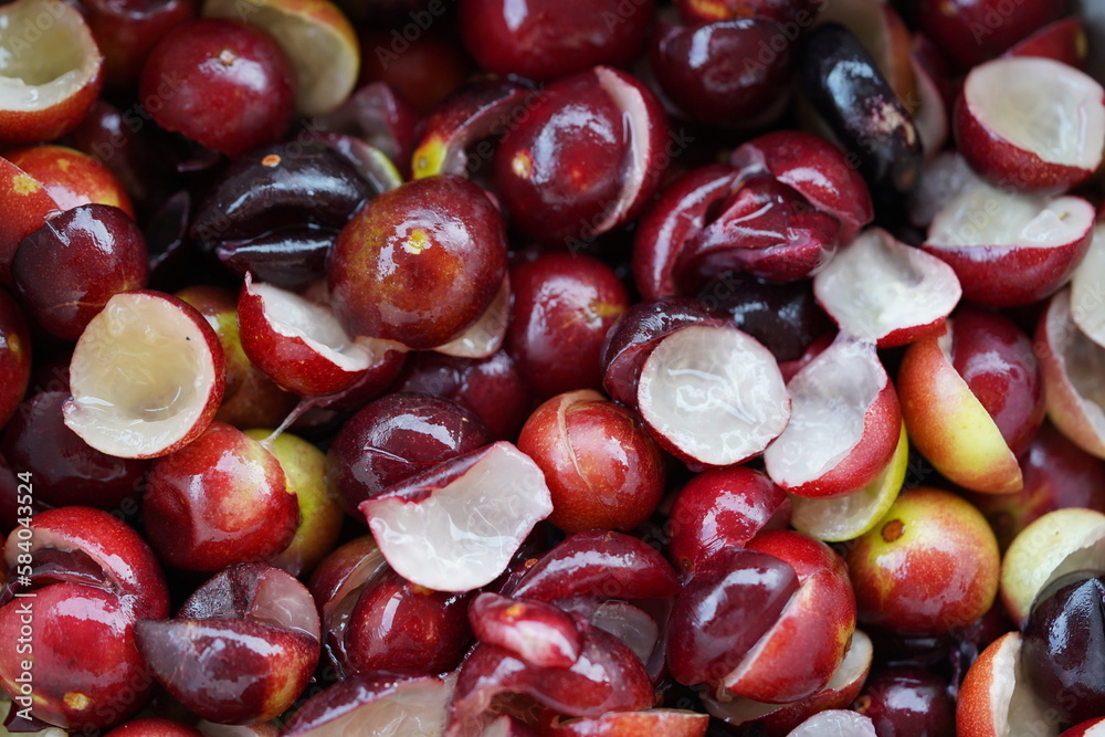 Ripe and partially deep red camu camu fruit after removing the seeds ...