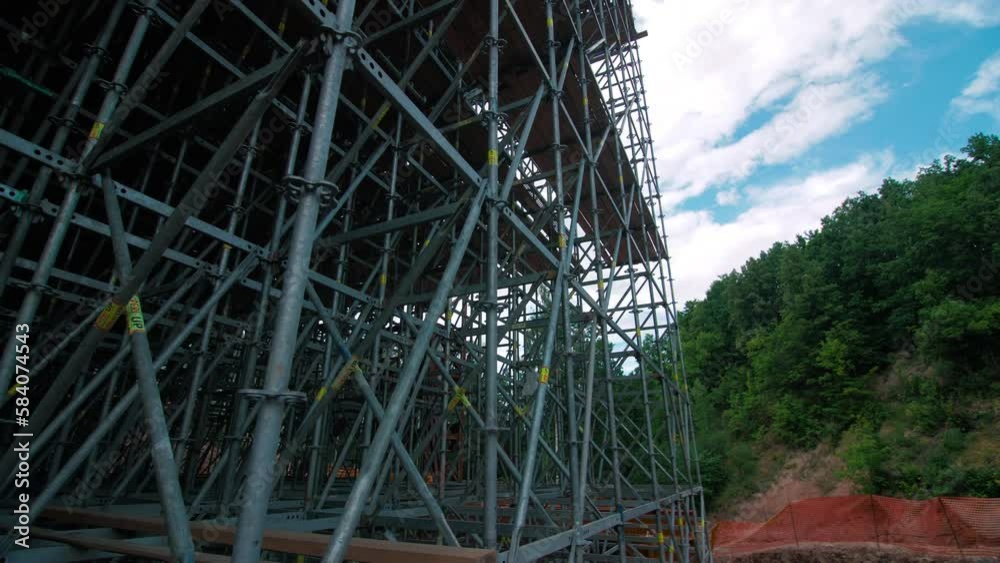 Building of road bridge support equipped with fittings and scaffolds ...