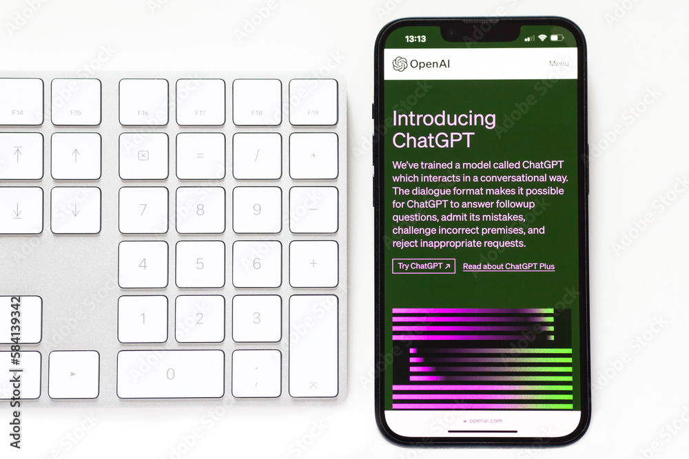 Foto de Openai Chatgpt neural network on the phone screen next to the keyboard. Programmer uses ...
