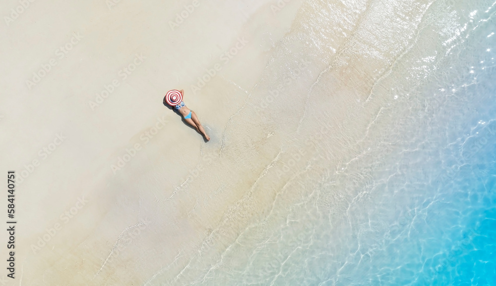 Aerial view with woman in bikini sunbathing as laying on the beach ...