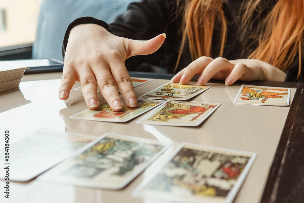 Tarot cards, Tarot card divination, esoteric background. A woman makes ...