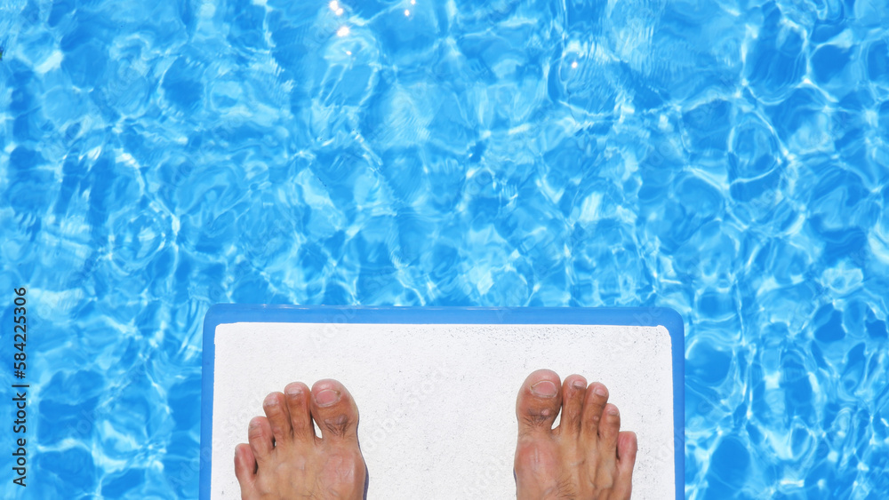 Feet on springboard of swimming pool , turquoise blue water. Stock ...
