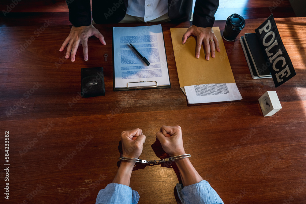 Law enforcement officer interrogating Criminals male with handcuffs in ...