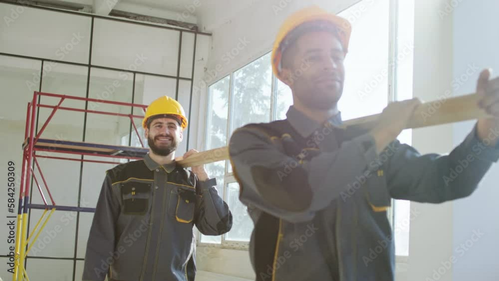 At construction site two young and charismatic men multiracial ...