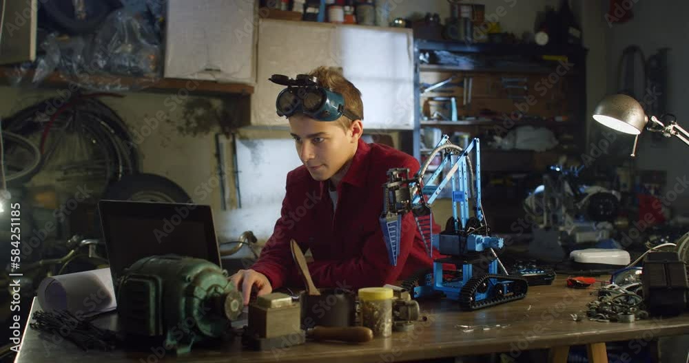 Portrait of Curious Teenage Boy Using Laptop and Remote Joystick to ...