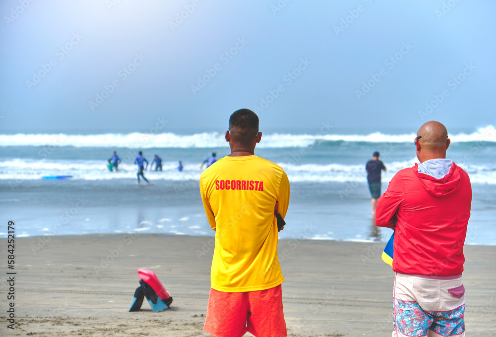Young lifeguard with a rescue orange buoy. Security measures on the ...