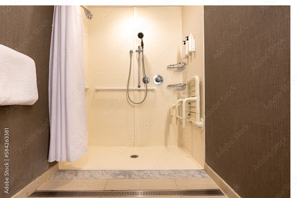 Wheelchair accessible hotel bathroom shower with tile floor and walls ...