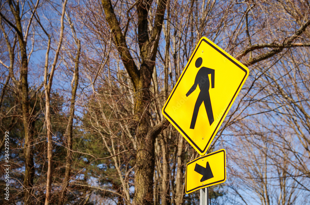 a pedestrian crossing yellow sign depicting danger in travel and ...