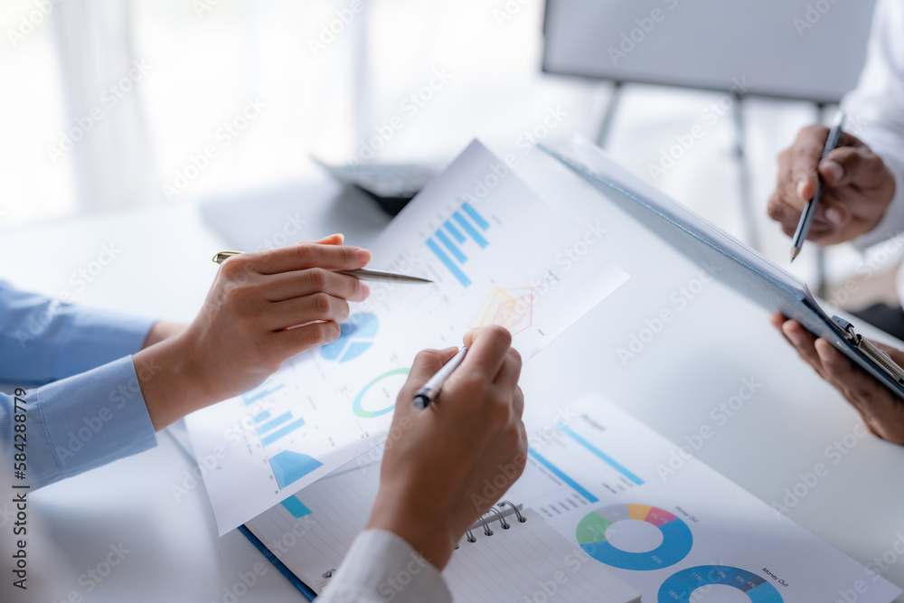 Business team together making investment plan at meeting pointing at ...