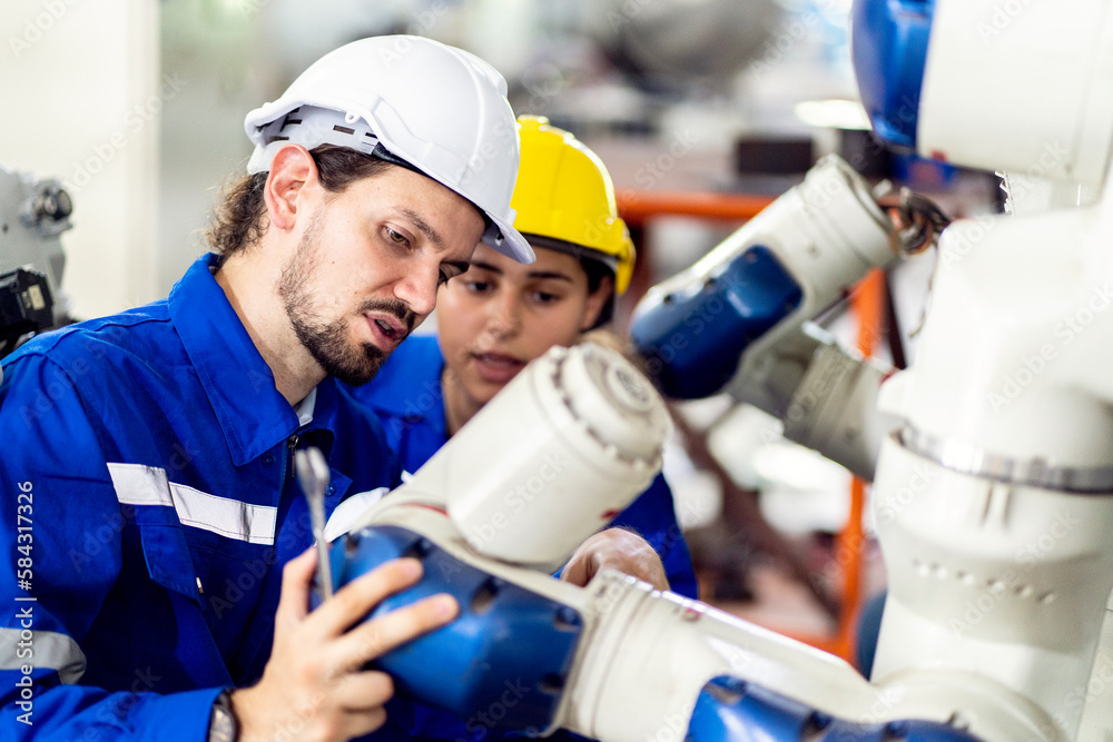 Male engineers and female assistants wearing safety uniforms and ...