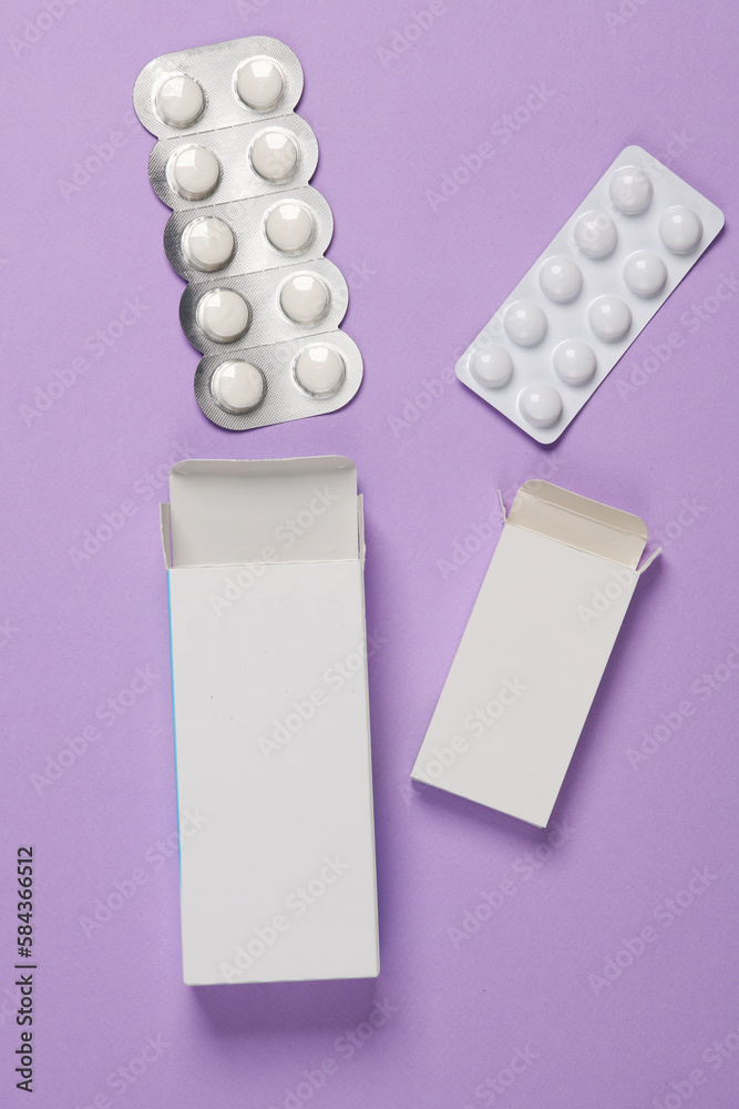 Pill blisters mockup with blank cardboard boxes packaging on purple ...