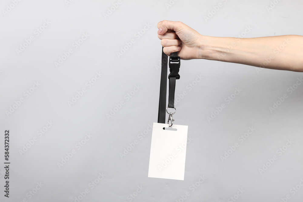 Hand holding Identification white blank id card on gray background ...
