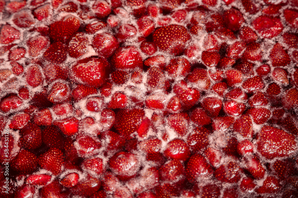 Strawberry jam simmering slightly, detailed close-up, top view ...