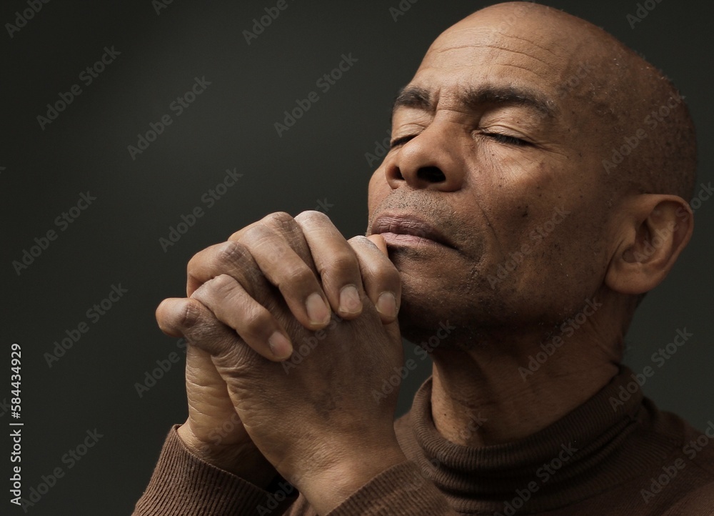man praying to god with hands together Caribbean man praying with black ...