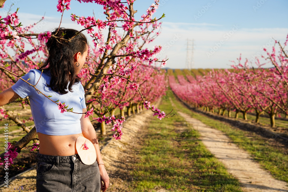 ostomized woman in a field of pink flowers in Aitona with the ostomy ...