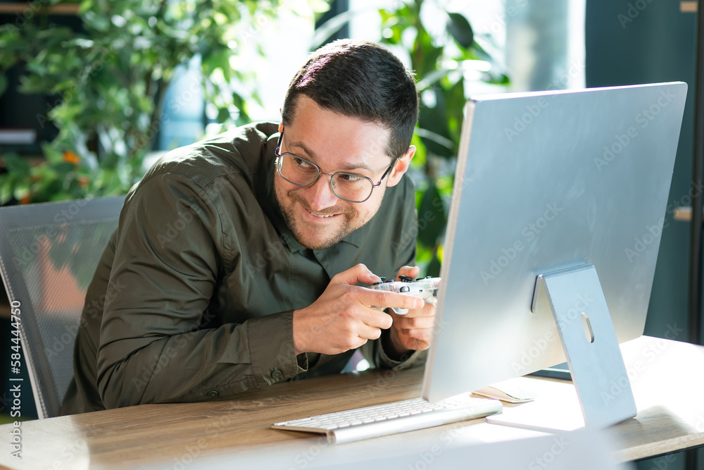 Funny confused office worker happy man employee gamers hold controller ...