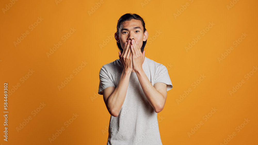 Asian adult sending air kisses on camera, acting funny and romantic in ...
