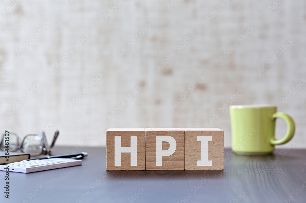 There is wood cube with the word HPI. It is an acronym for Human ...