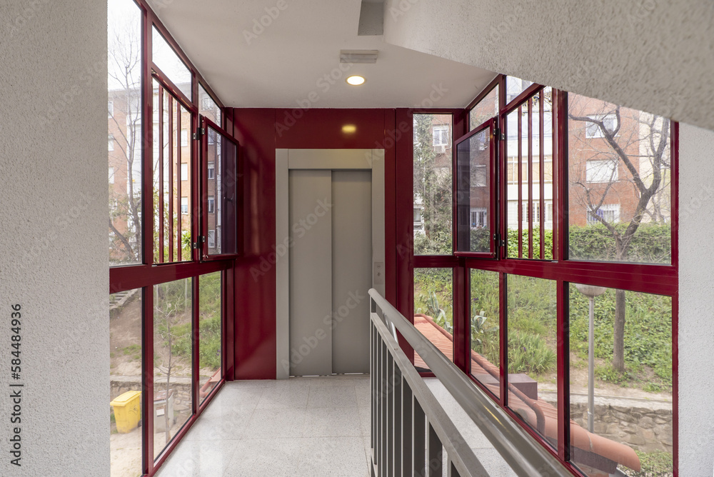 An elevator in a retrofit residential building with an external metal ...