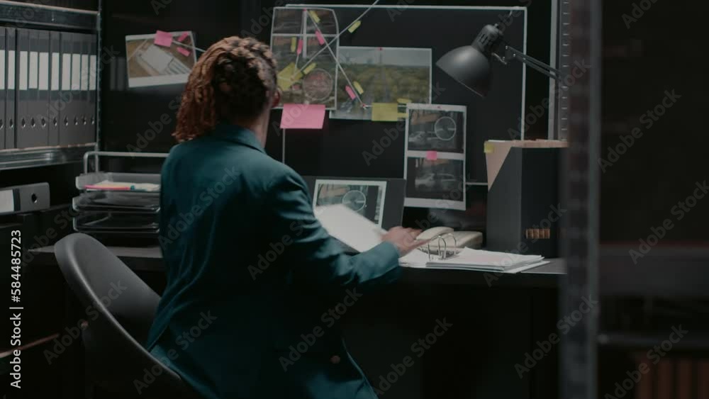 Police investigator examining clues from crime scene, looking at ...