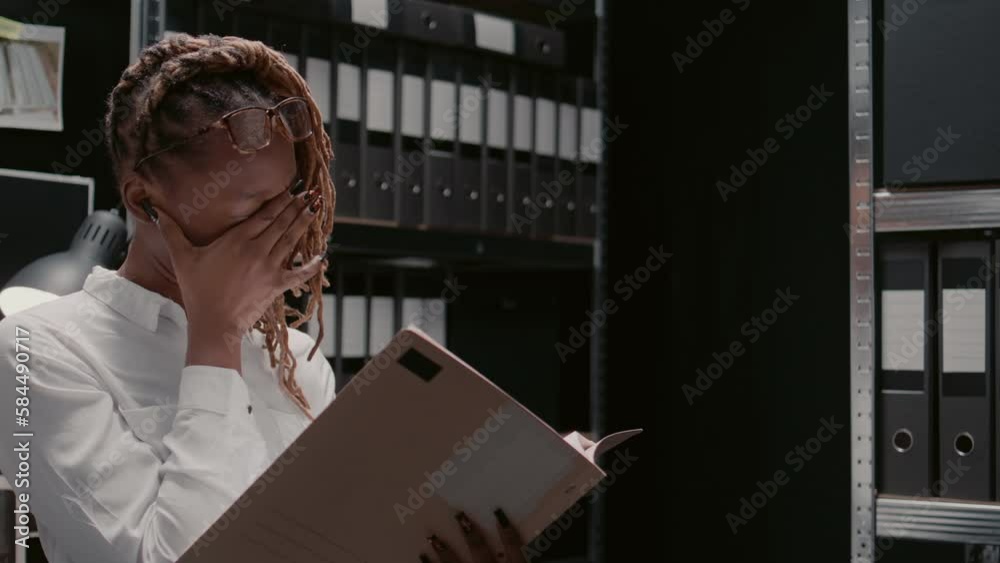 Policewoman analyzing gathered case information in law agency office ...