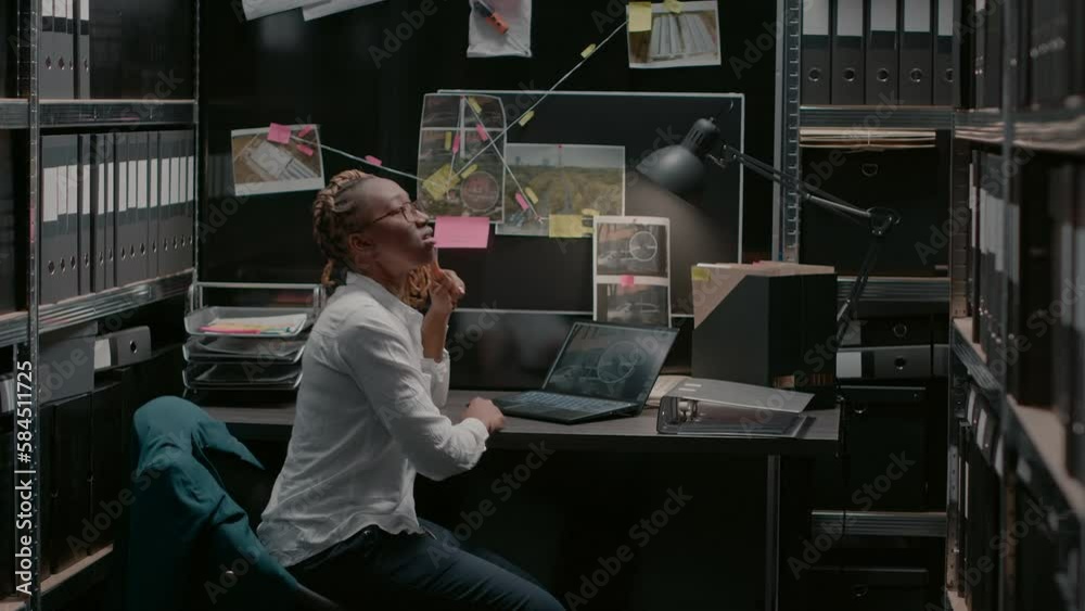 Law officer checking forensic evidence in police office, looking at ...