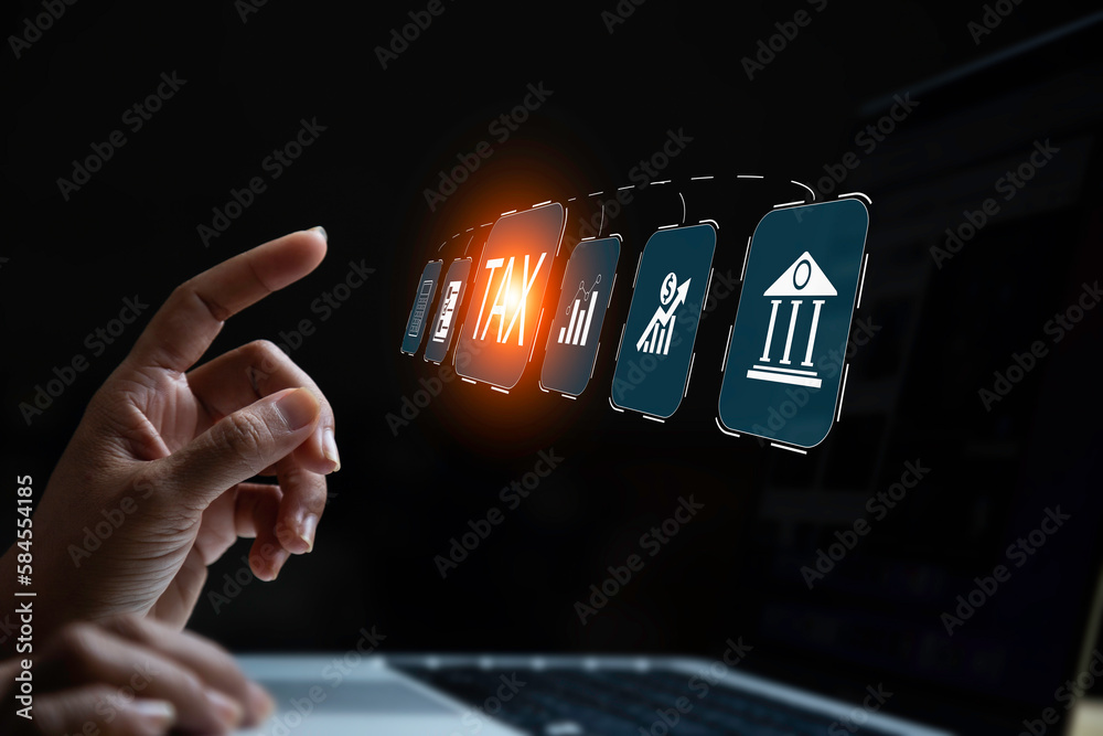 Businessman using laptop to fill in the income tax online return form ...