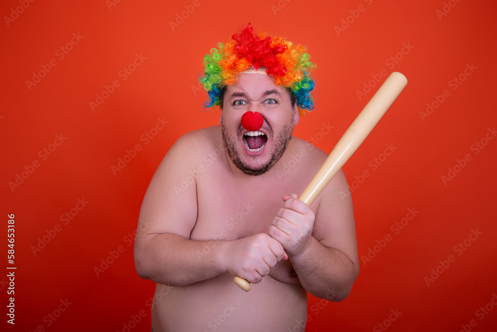 Funny fat man in a clown costume. Joy and anger. Stock Photo | Adobe Stock