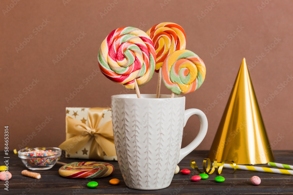 Colorful candies in cup on table on light background background. Large ...
