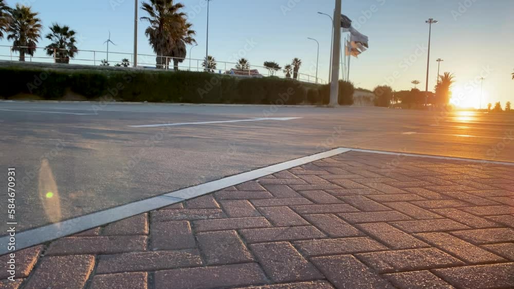 Video „The rising sun casts a warm glow over the empty parking lot ...