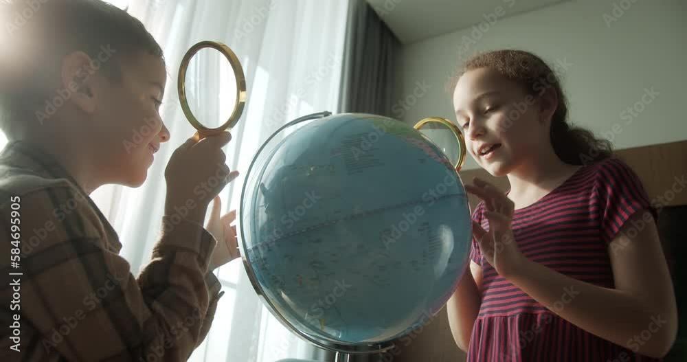 Vidéo Stock Children is studying while sitting at home in rays sunset ...