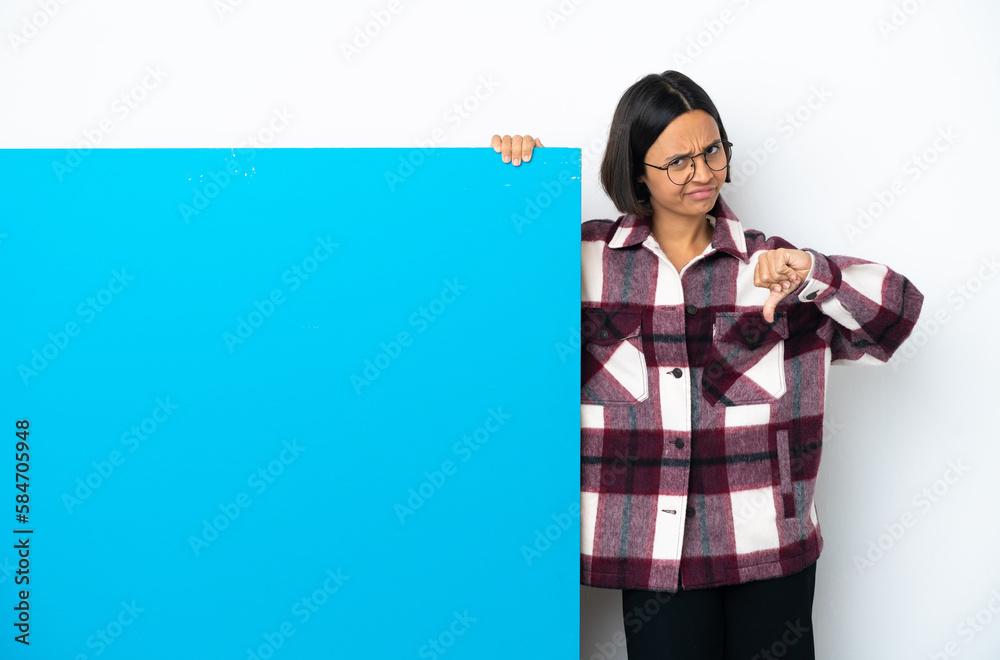 Young mixed race woman with a big blue placard isolated on white ...