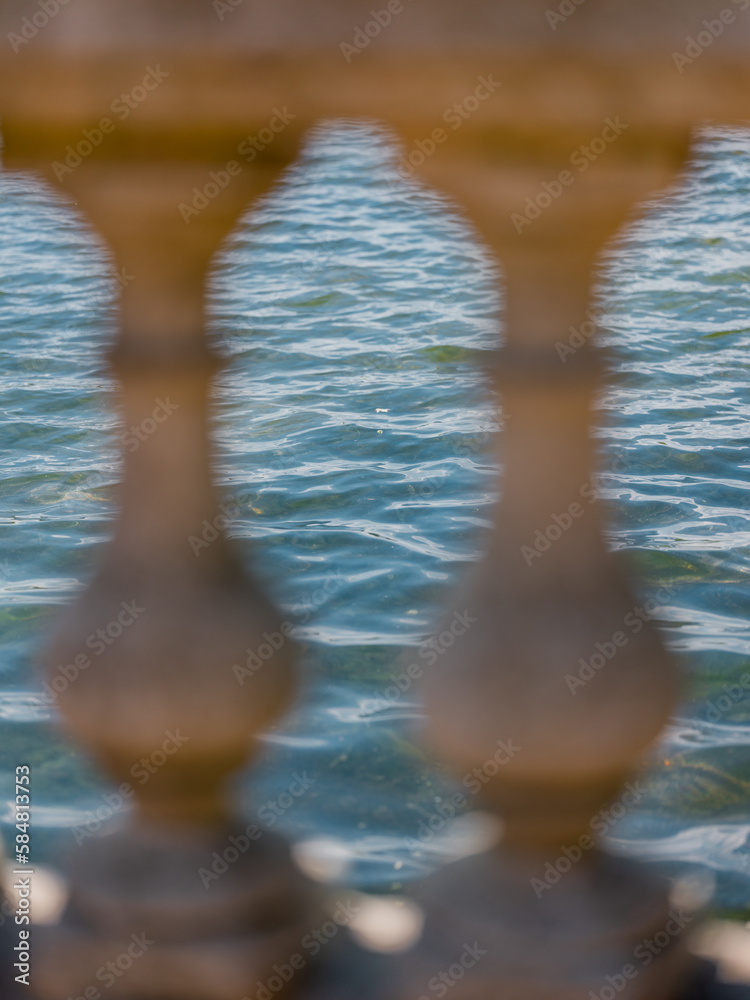 Water seen through stone pillars Stock Photo | Adobe Stock