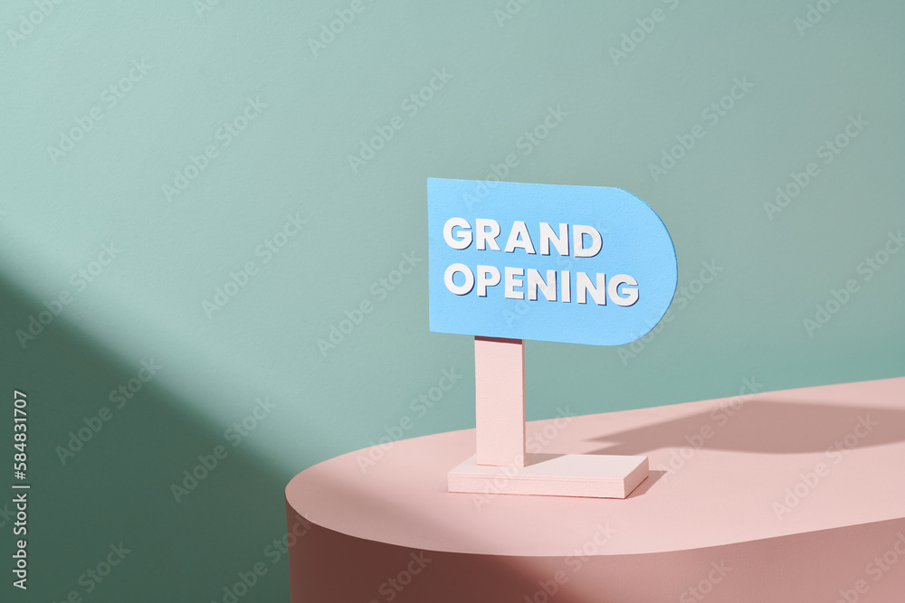 Grand Opening sign write in blue chalk on a wooden sign label on shelf ...