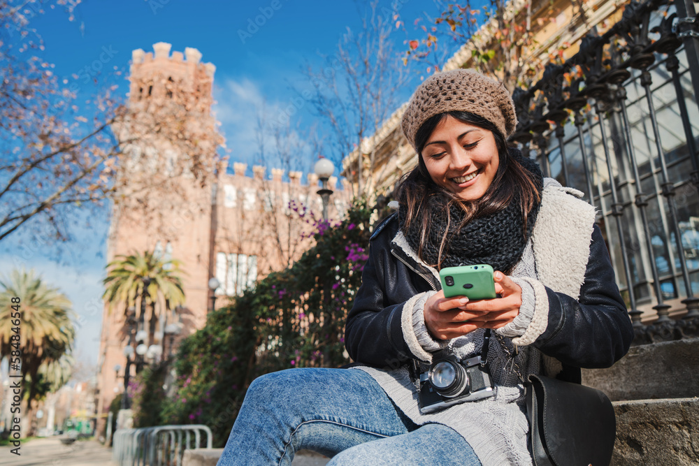 Young asian woman using a cellphone app for texting messages in a ...
