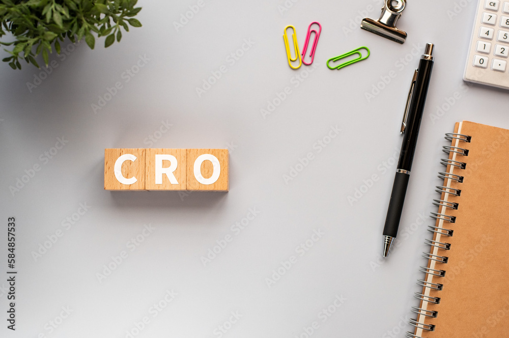 There is wood cube with the word CRO.It is an abbreviation for Contract ...