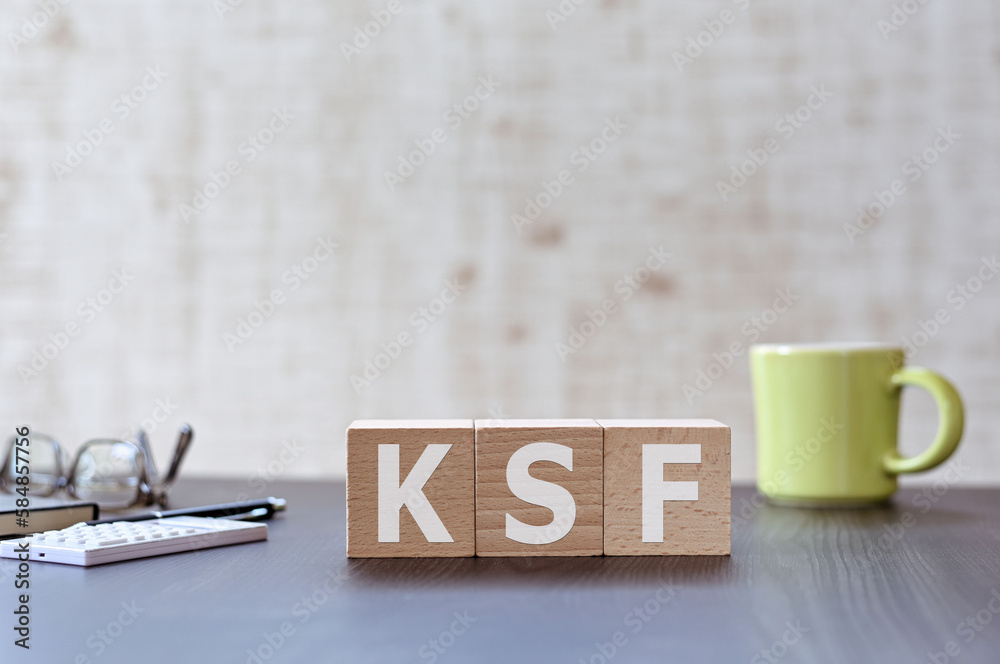 There is wood cube with the word KSF. It is an acronym for Key Success ...
