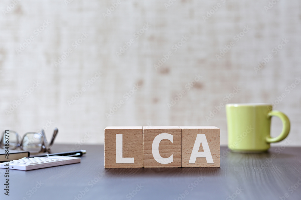 There is wood cube with the word LCA. It is an acronym for Life Cycle ...
