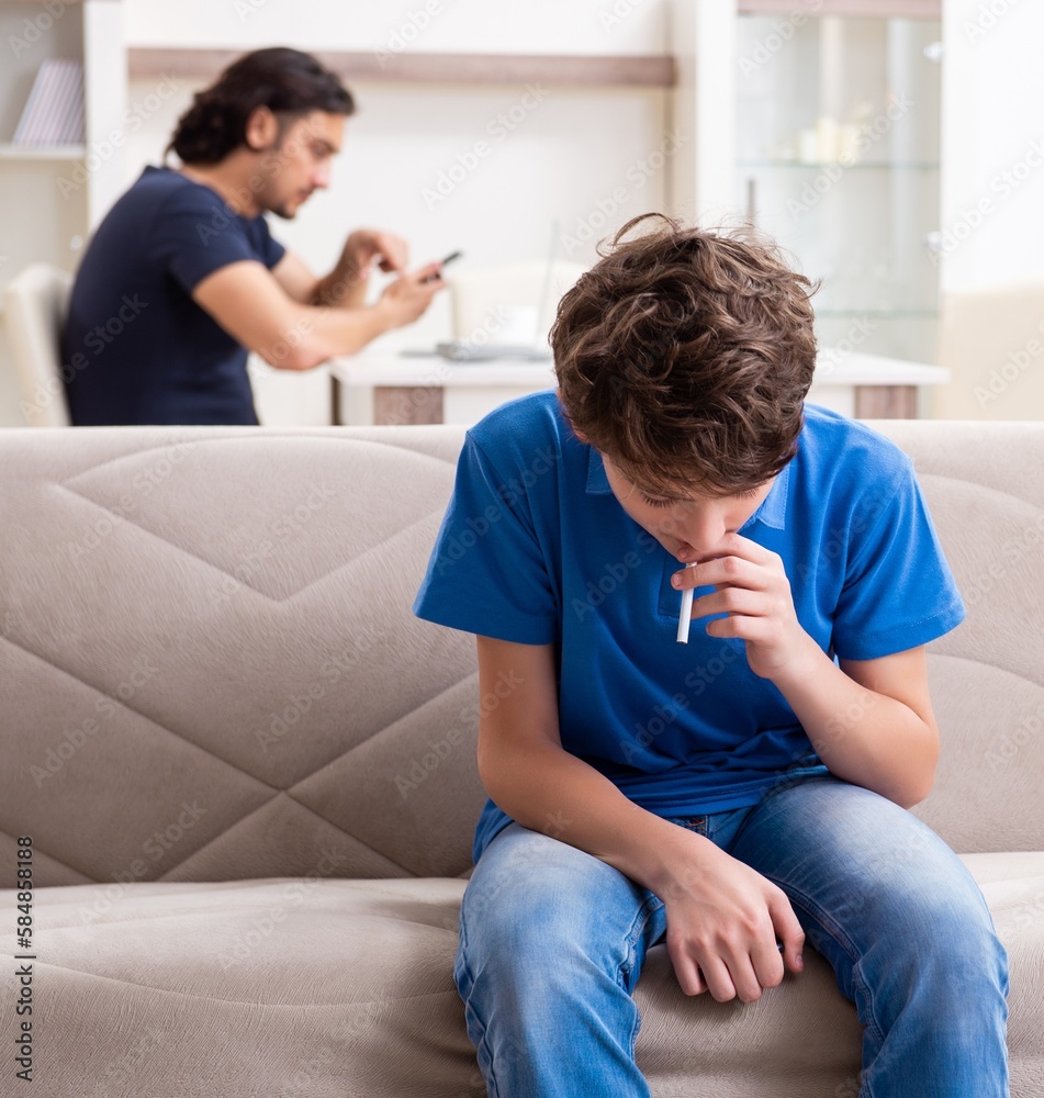 Concept of underage smoking with young boy and family Stock Photo ...