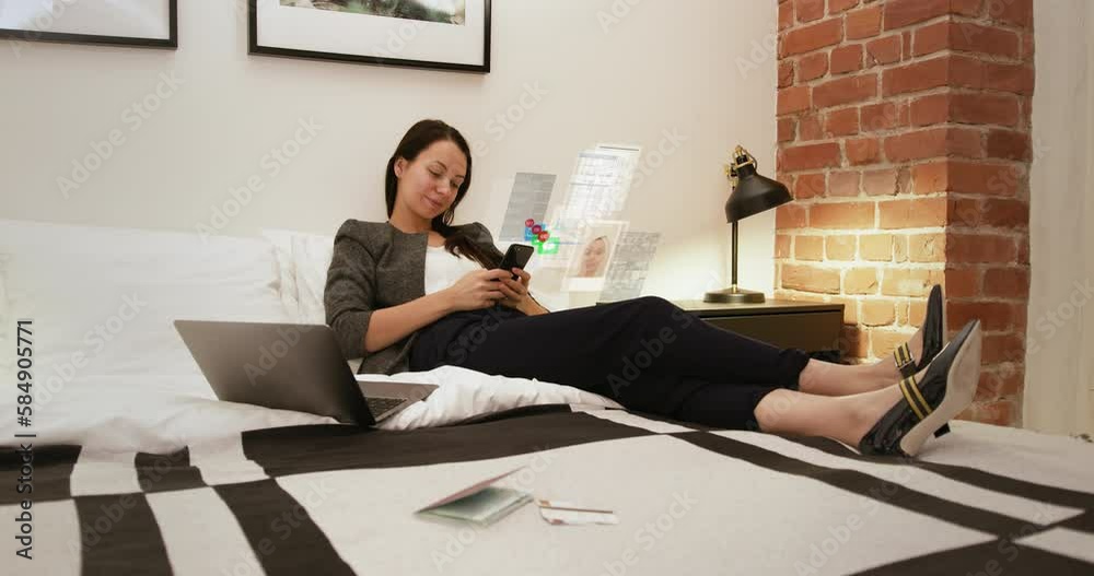 Young beautiful woman after working day still receives emails and ...