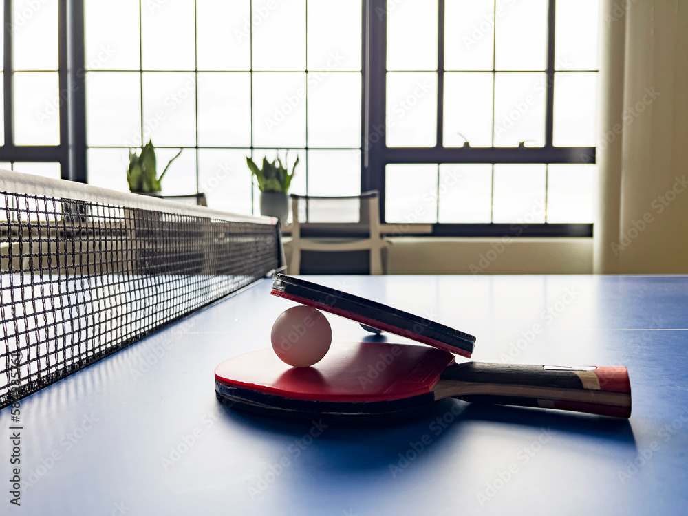 Ping Pong table with paddles and ball Stock Photo | Adobe Stock